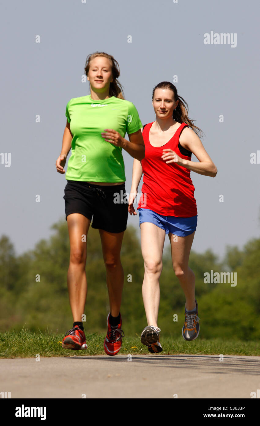 Two female hobby runners. Jogging in nature, in summer Stock Photo - Alamy