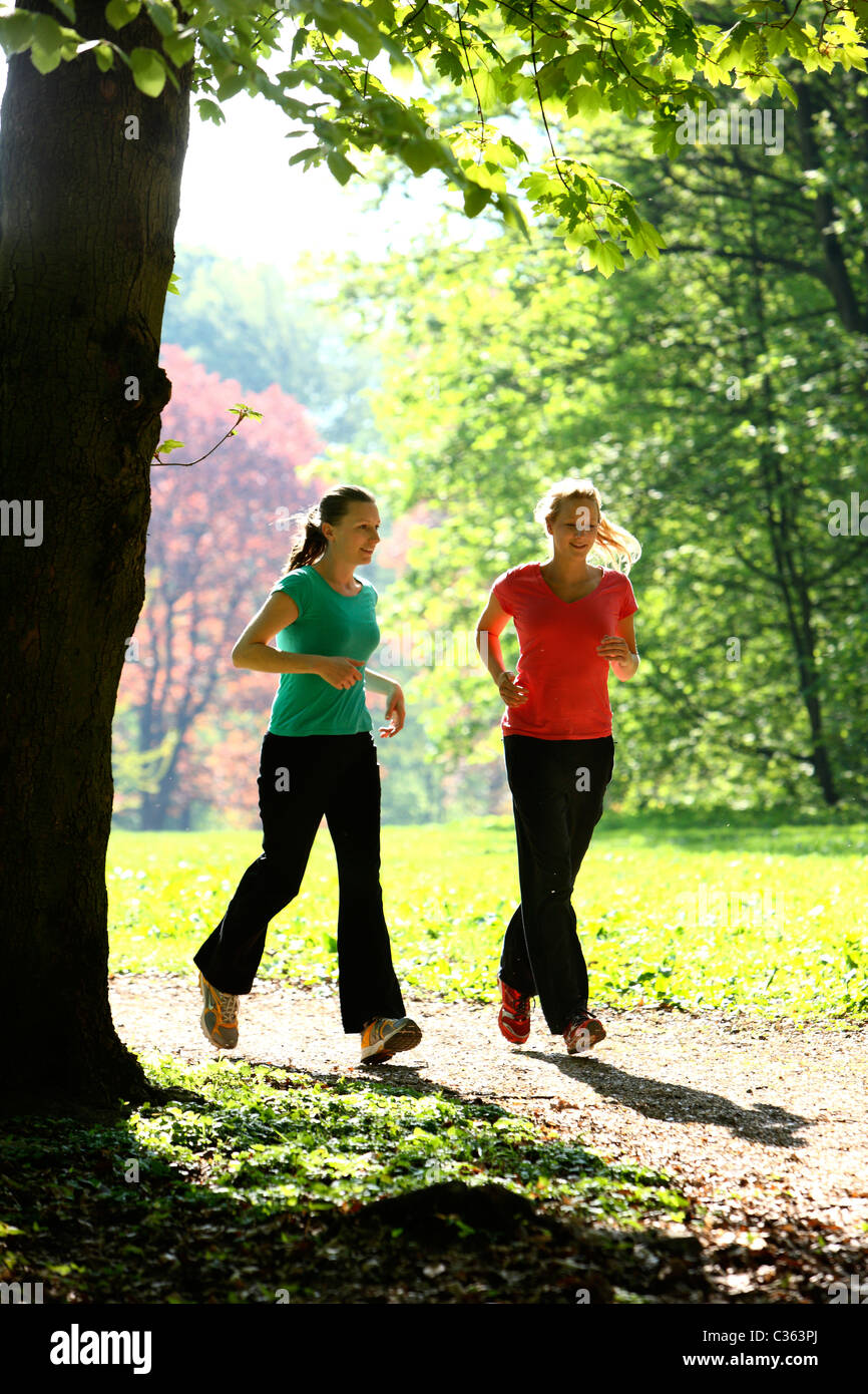 Two female hobby runners, jogging in a forest in summer Stock Photo - Alamy