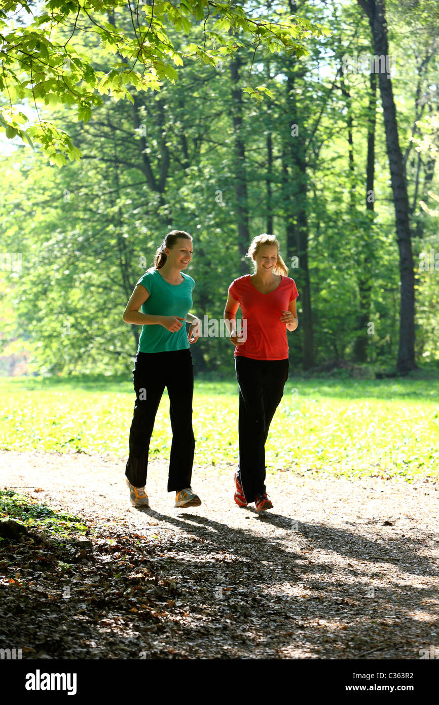 Two female hobby runners, jogging in a forest in summer Stock Photo - Alamy