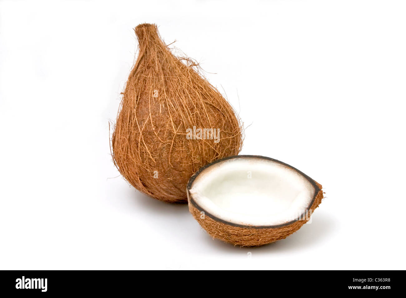 Coconut open, isolated on a white background and a full coconut Stock ...