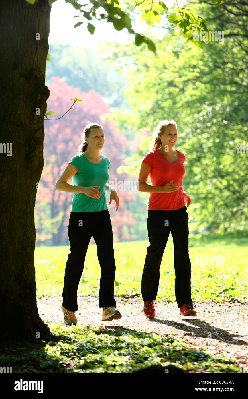 Two female hobby runners, jogging in a forest in summer Stock Photo - Alamy