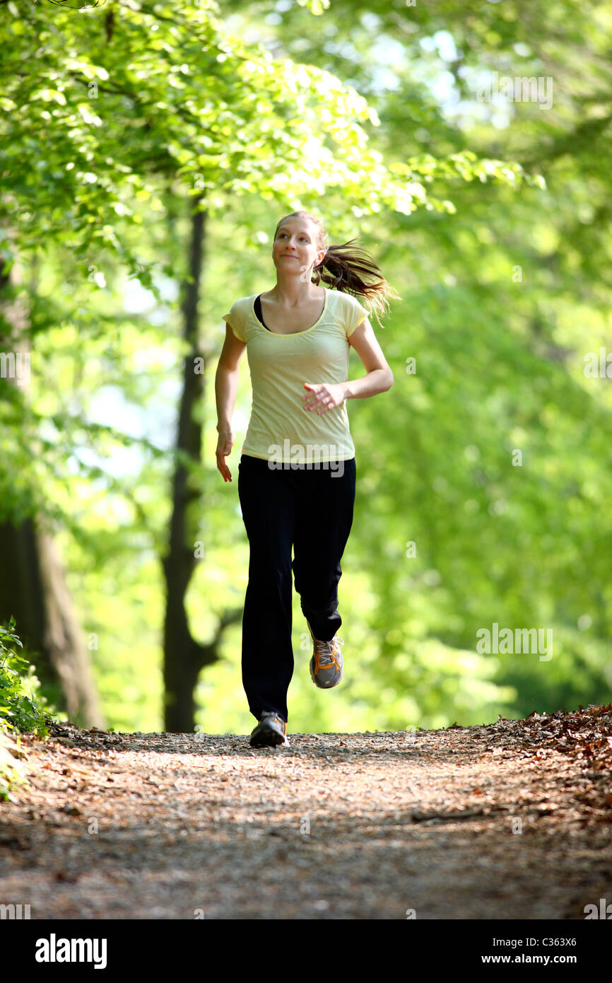 Two female hobby runners, jogging in a forest in summer Stock Photo - Alamy