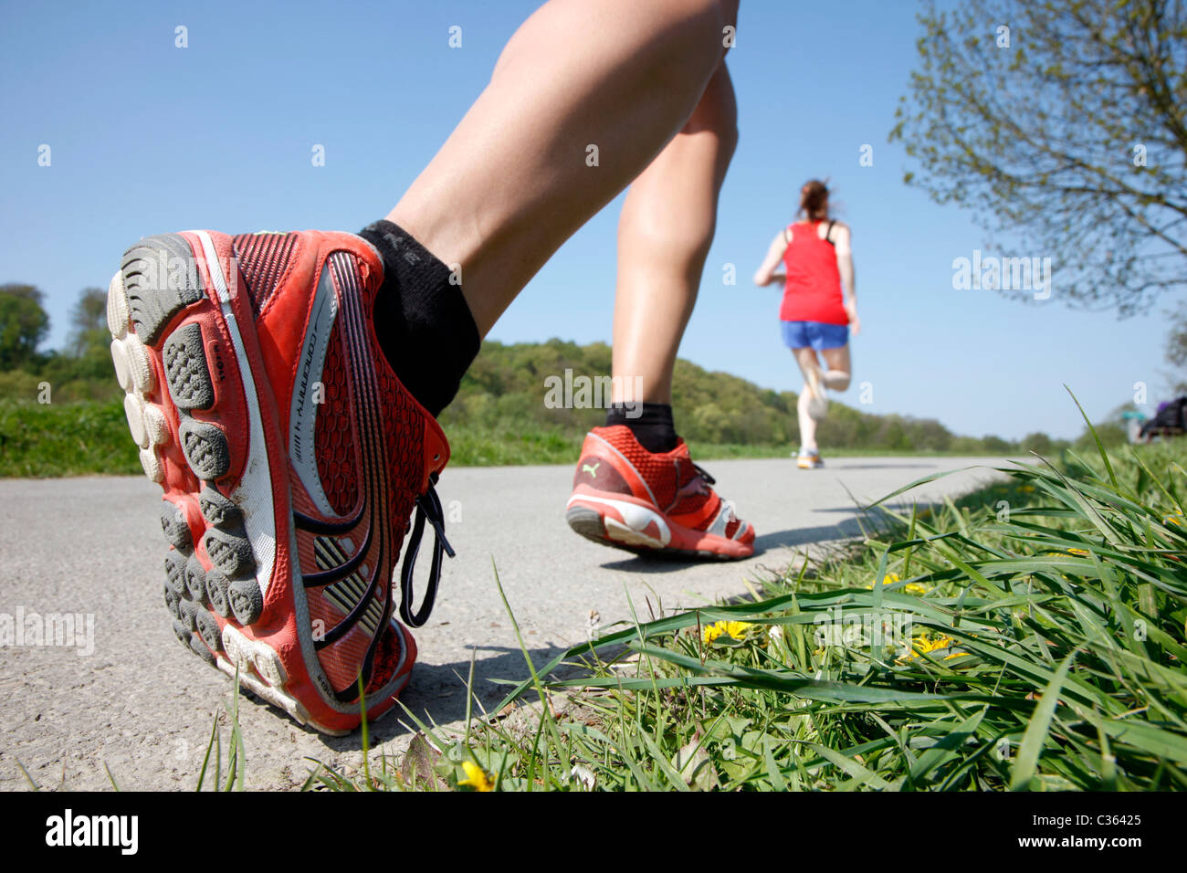 Two female hobby runners. Jogging in nature Stock Photo - Alamy