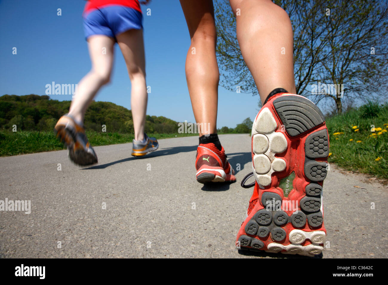 Two female hobby runners. Jogging in nature Stock Photo - Alamy