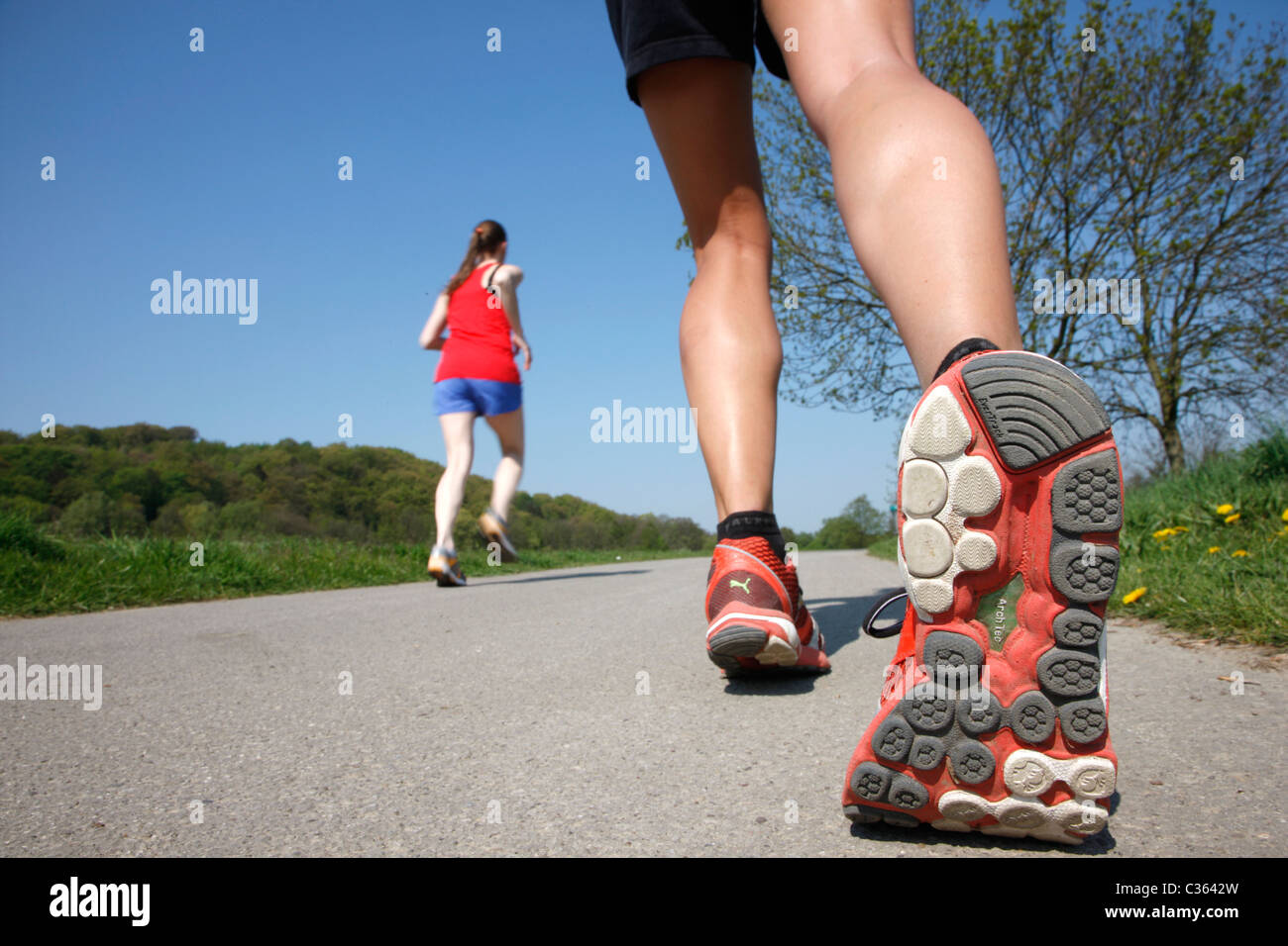 Two female hobby runners. Jogging in nature Stock Photo - Alamy