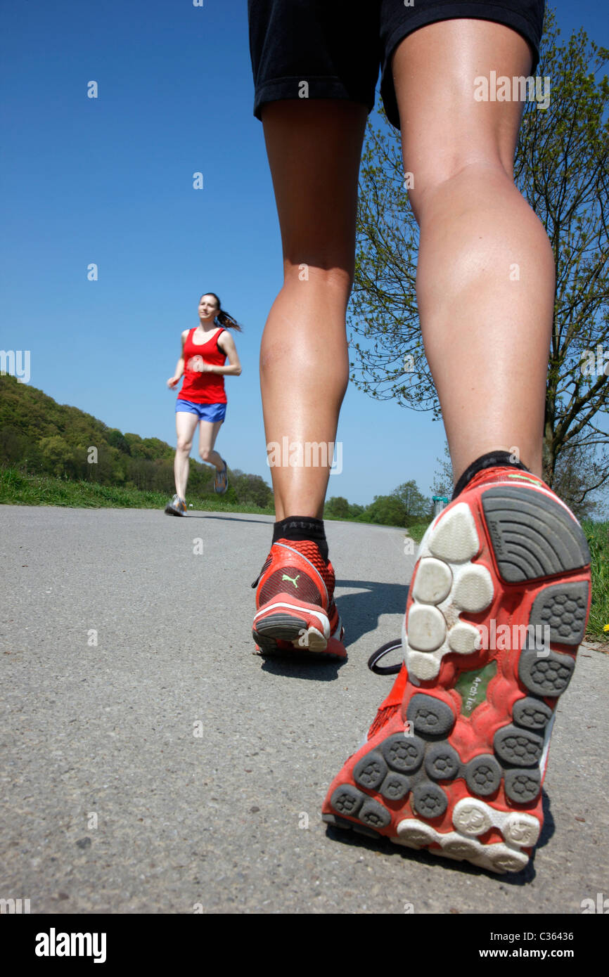 Two female hobby runners. Jogging in nature Stock Photo - Alamy