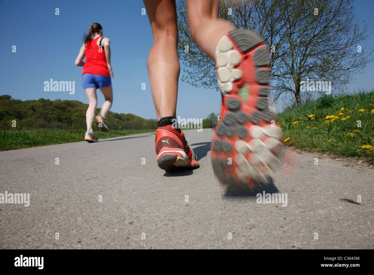 Two female hobby runners. Jogging in nature Stock Photo - Alamy