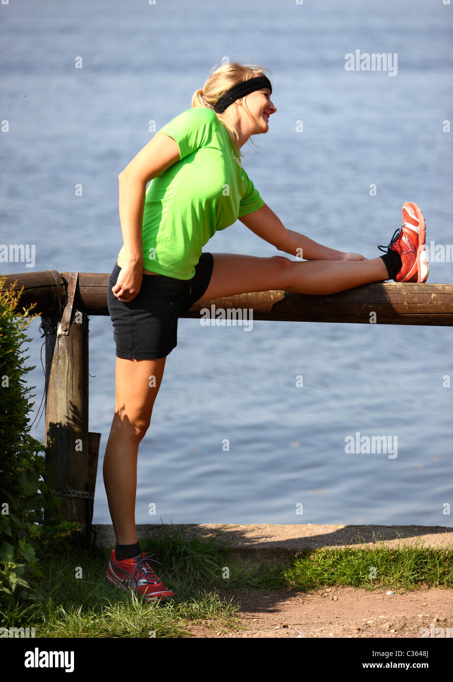 Two female hobby runners, stretching after jogging exercise Stock Photo ...