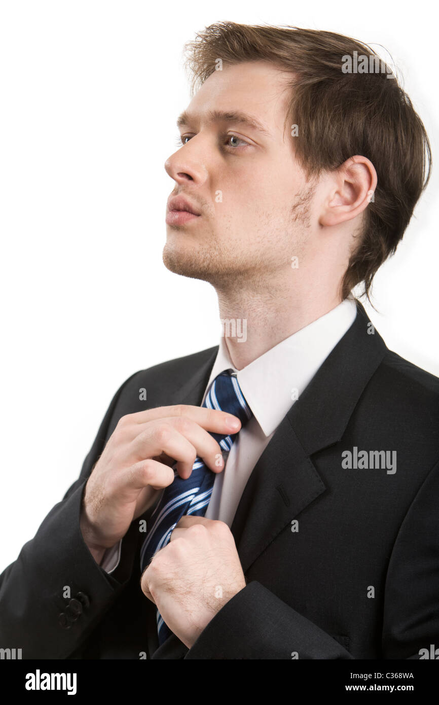Photo of elegant man getting dressed isolated over white background ...