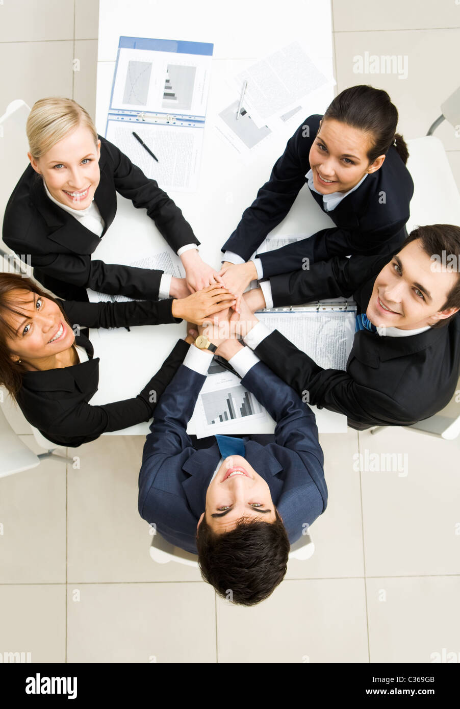 Above view of business people with their hands on top of each other and ...