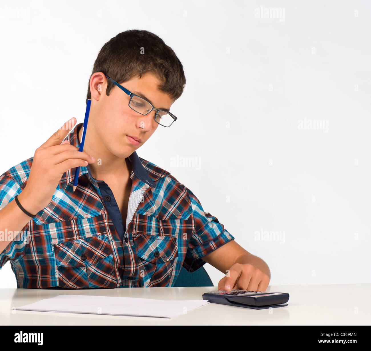 Teenager working for his maths subject with a calculator Stock Photo ...