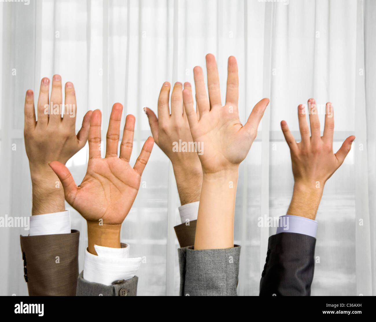 Close-up of several human hands raised simultaneously Stock Photo - Alamy