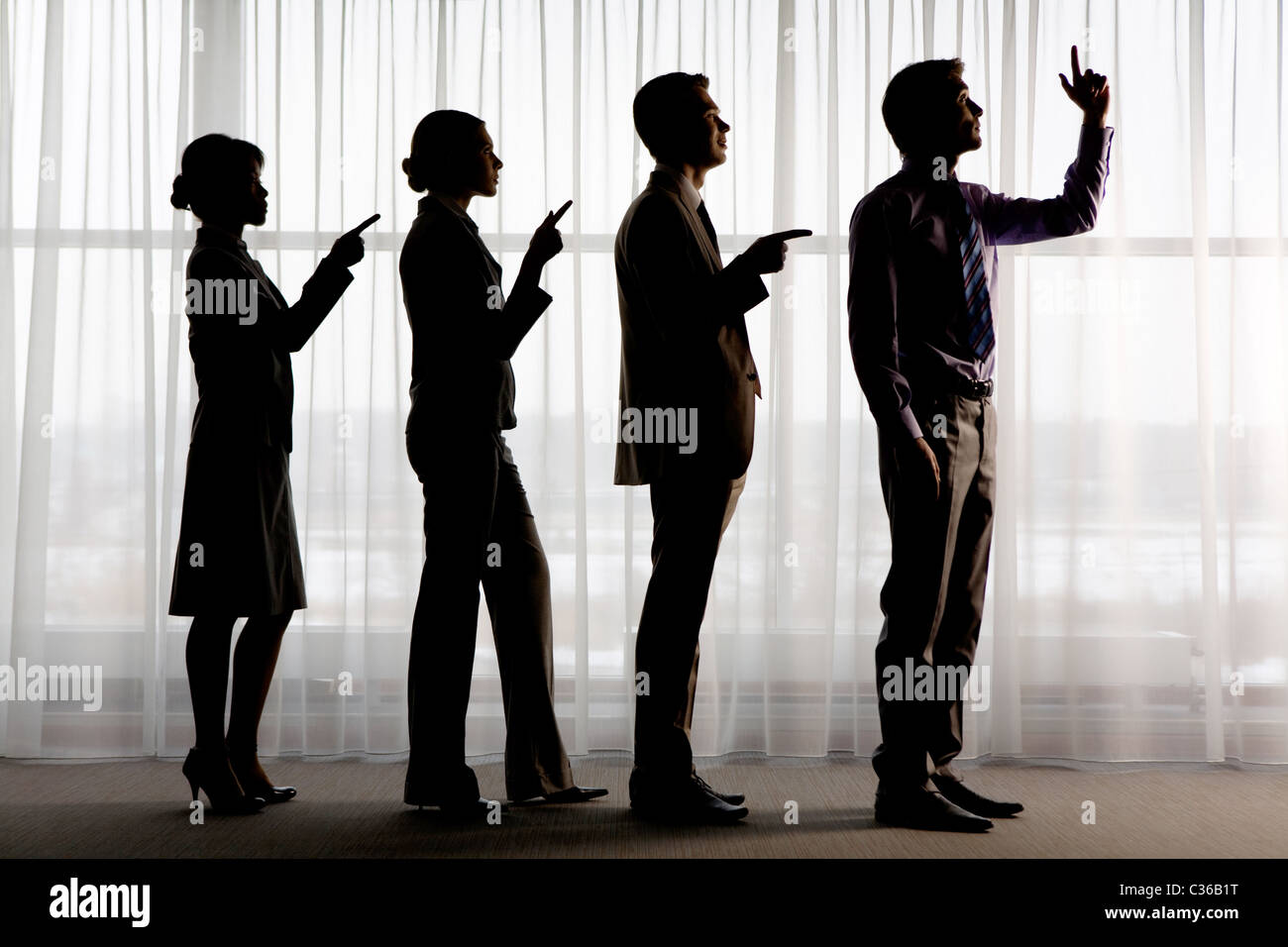 Silhouettes of contemporary business people standing in line with ...