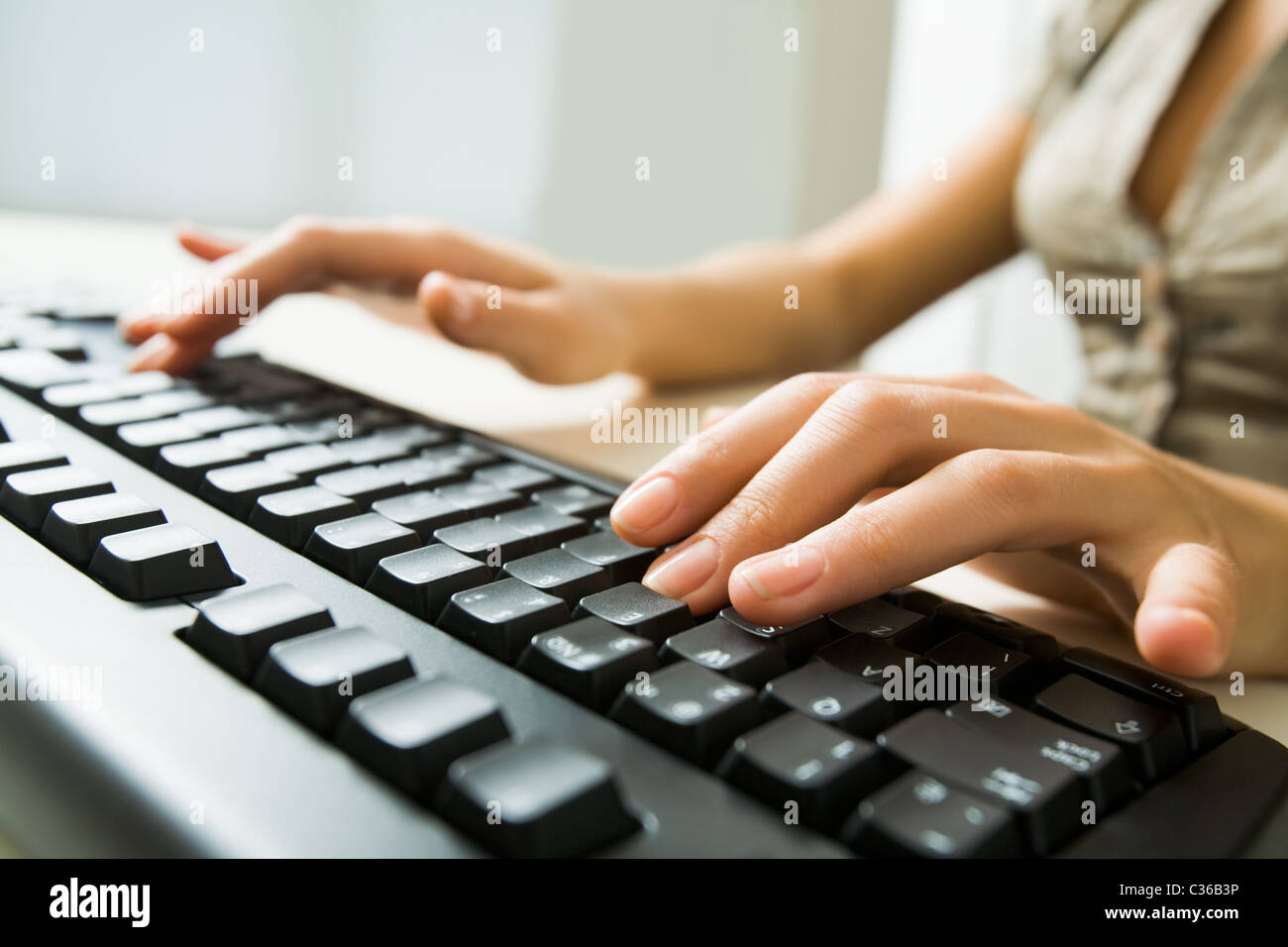 Close-up of female hands touching buttons of black keyboard Stock Photo ...