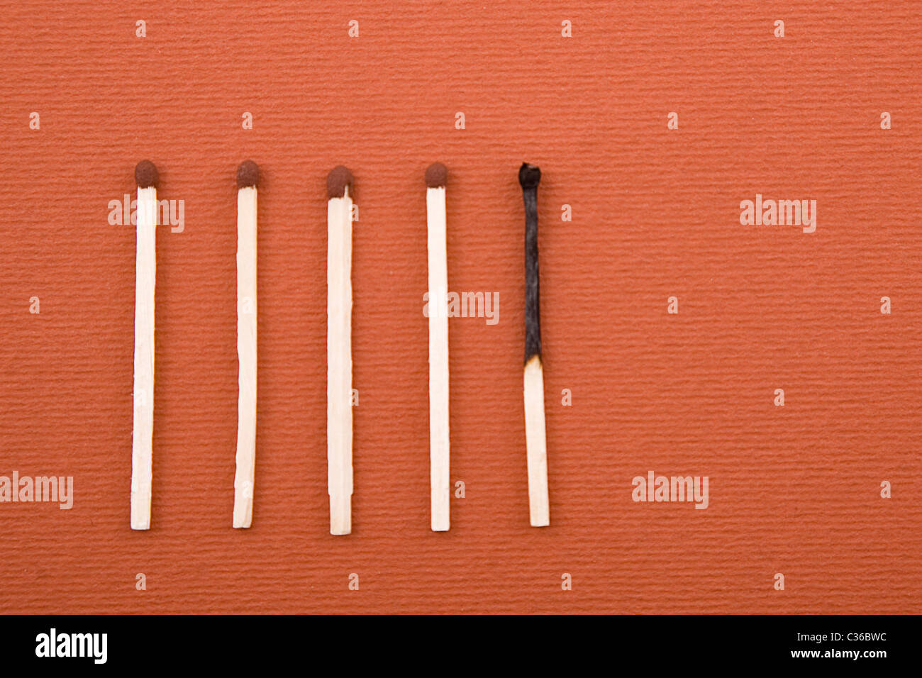 five matches on red background Stock Photo - Alamy