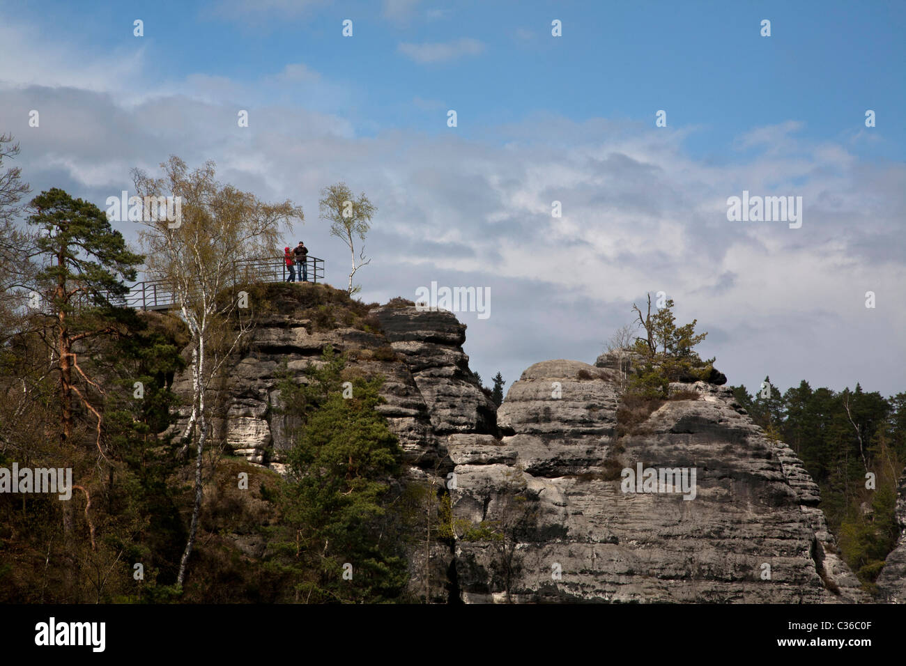 Two people looking out over the rocks at Bastei, Germany Stock Photo ...