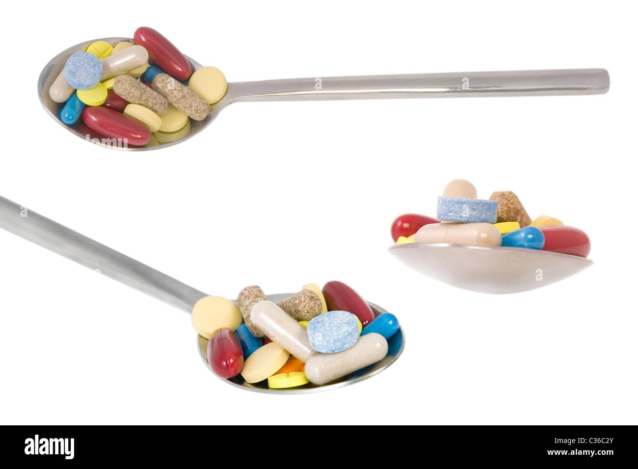 three point of view from teaspoon with pills and capsules isolated on ...