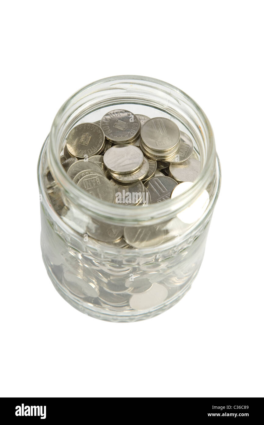 glass jar with silver coins on white background Stock Photo - Alamy