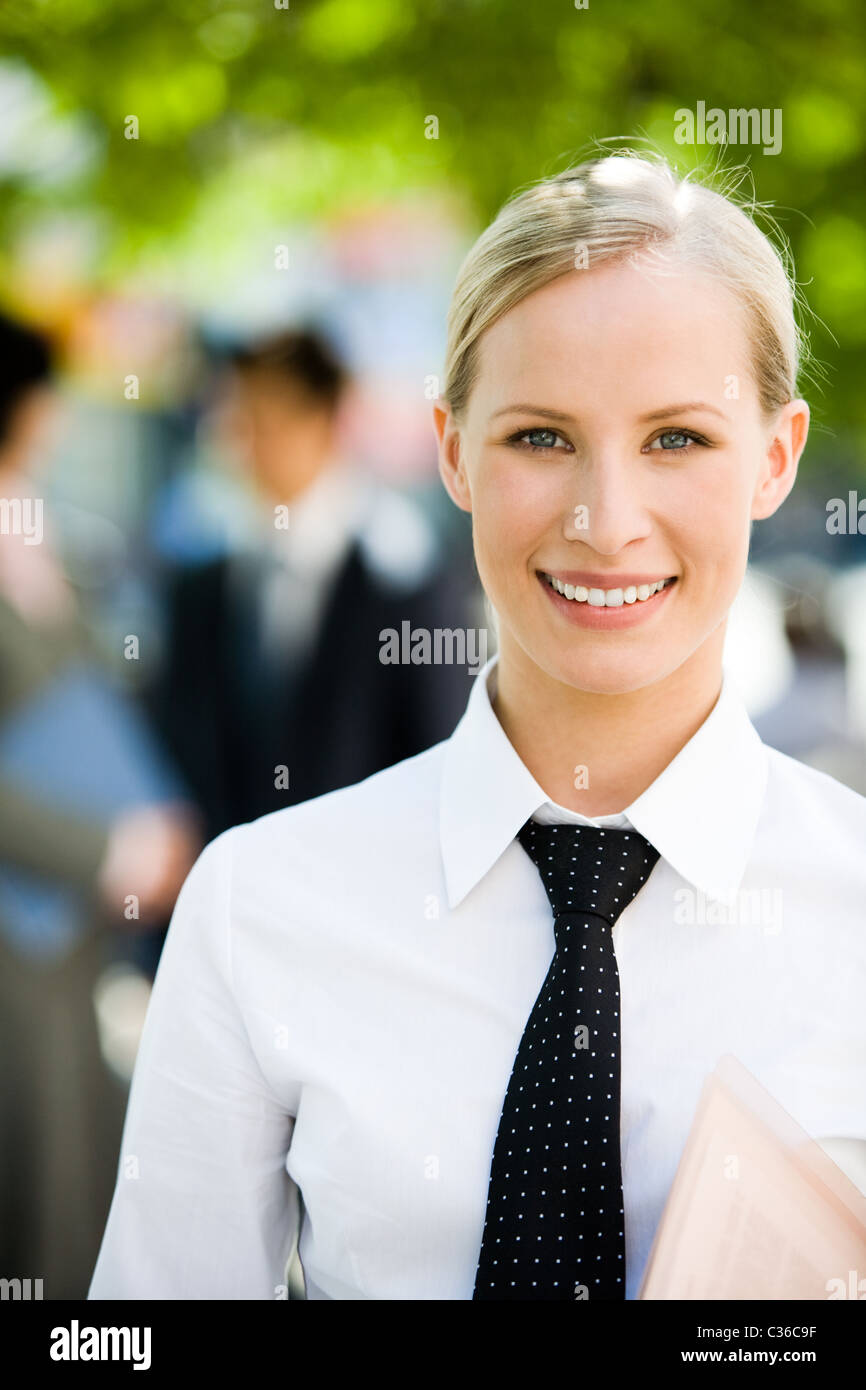 Portrait of pretty employer looking at camera with smile outside Stock ...