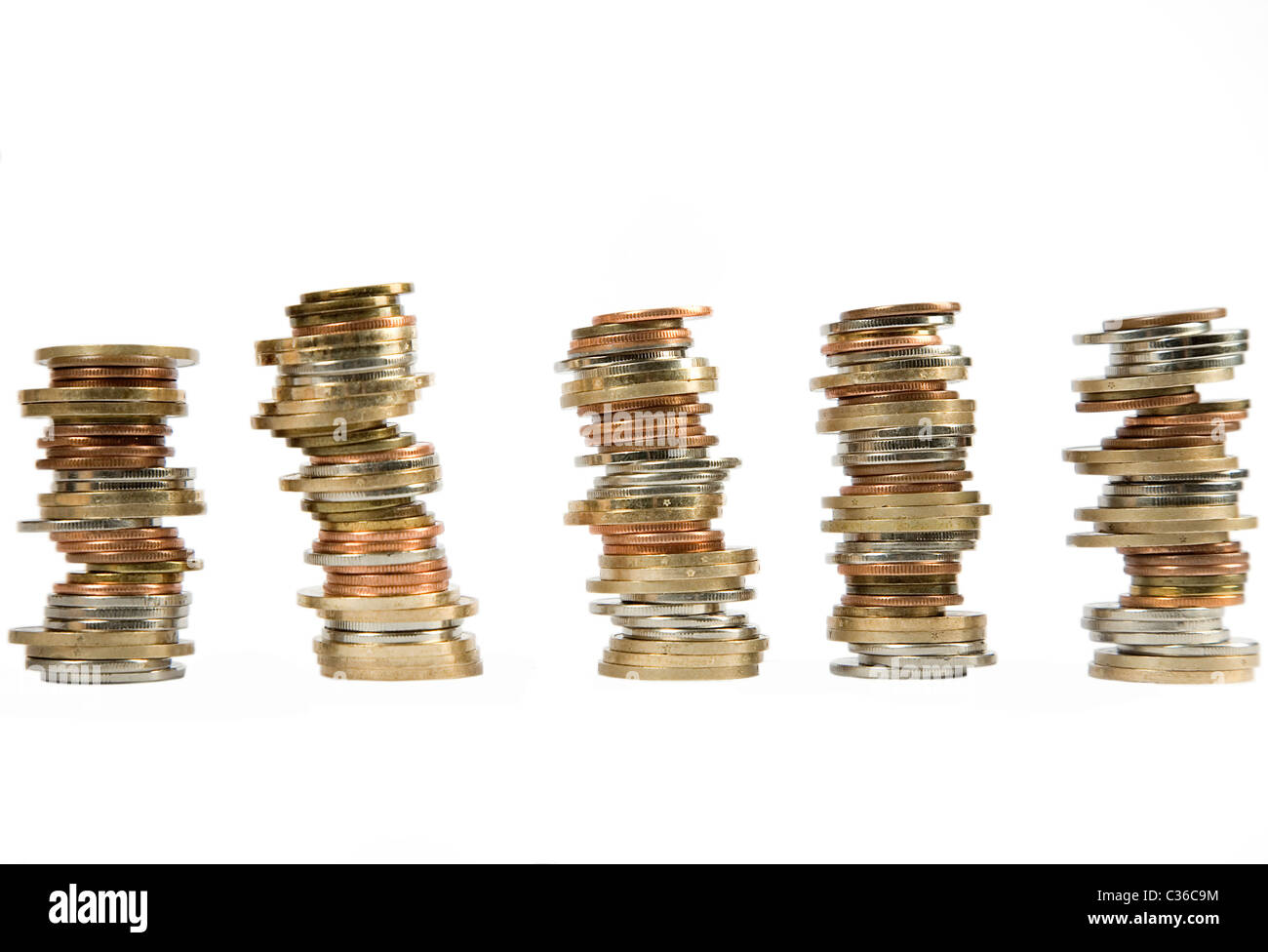 many money coins stacked up on a white background Stock Photo - Alamy
