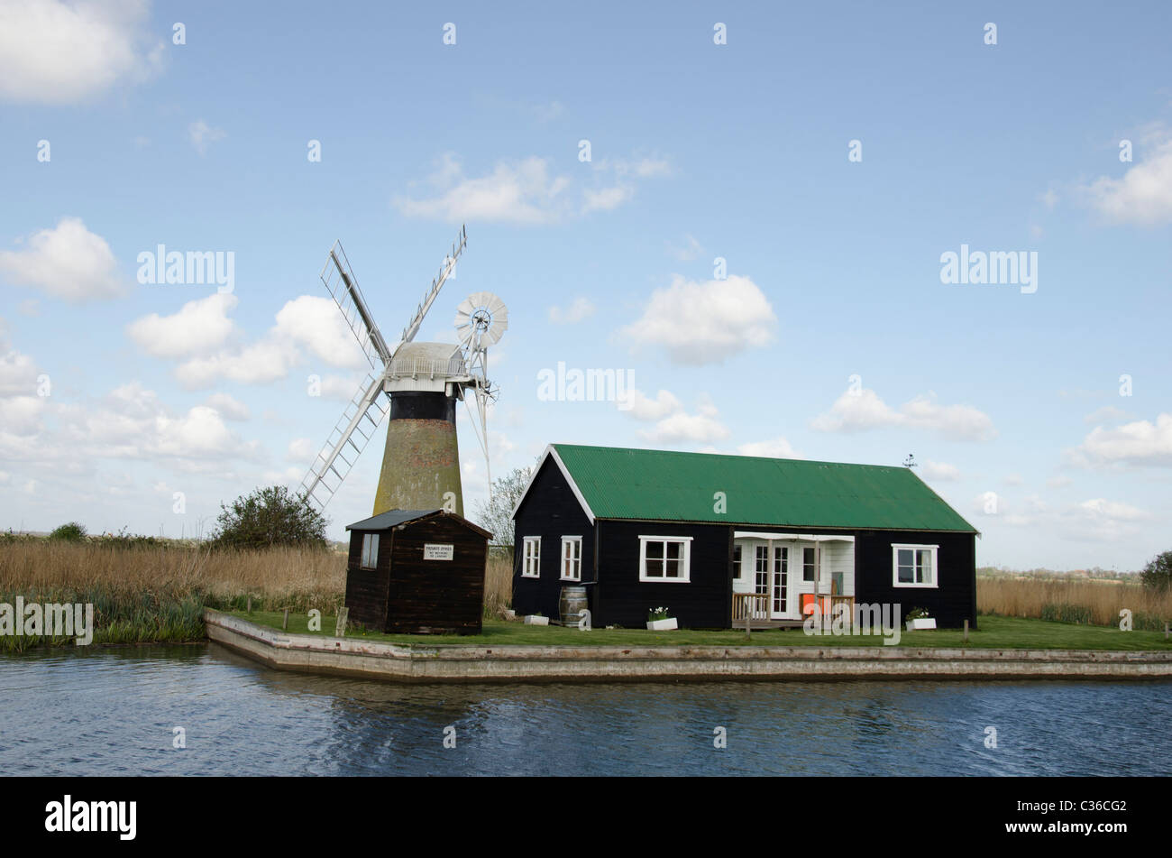 Old wind-powered drainage pump and house with water frontage on the ...