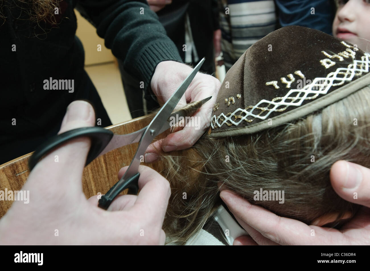 Shalev, Young Jewish boy of three having his first ritual haircut ...