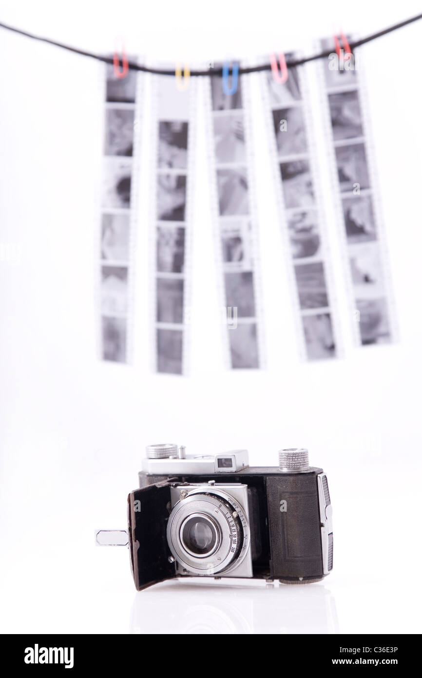 Old-time rusty photo-camera and film strips on white background Stock ...