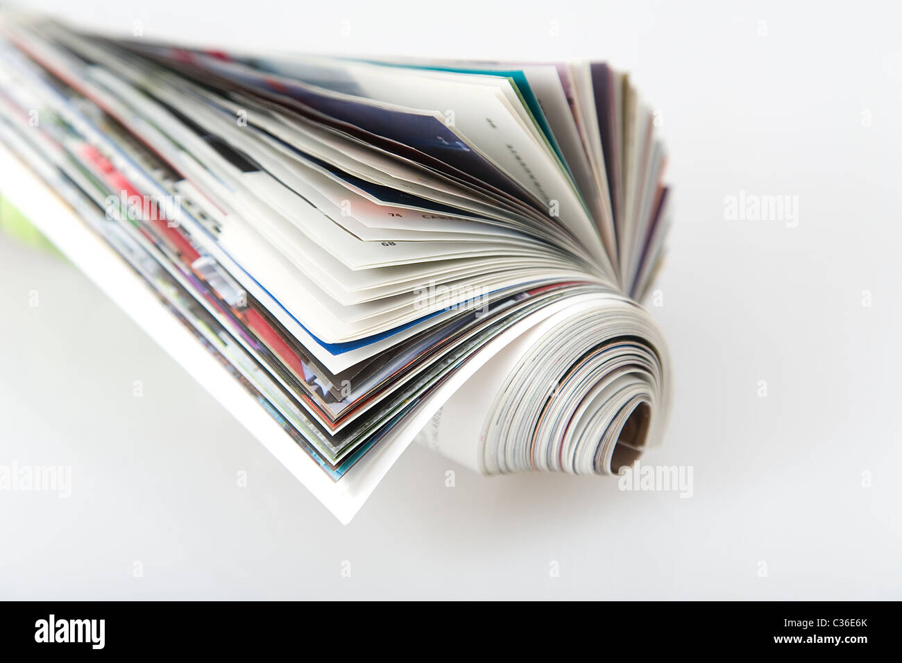 front view of roll magazine, colored newspaper on white background ...