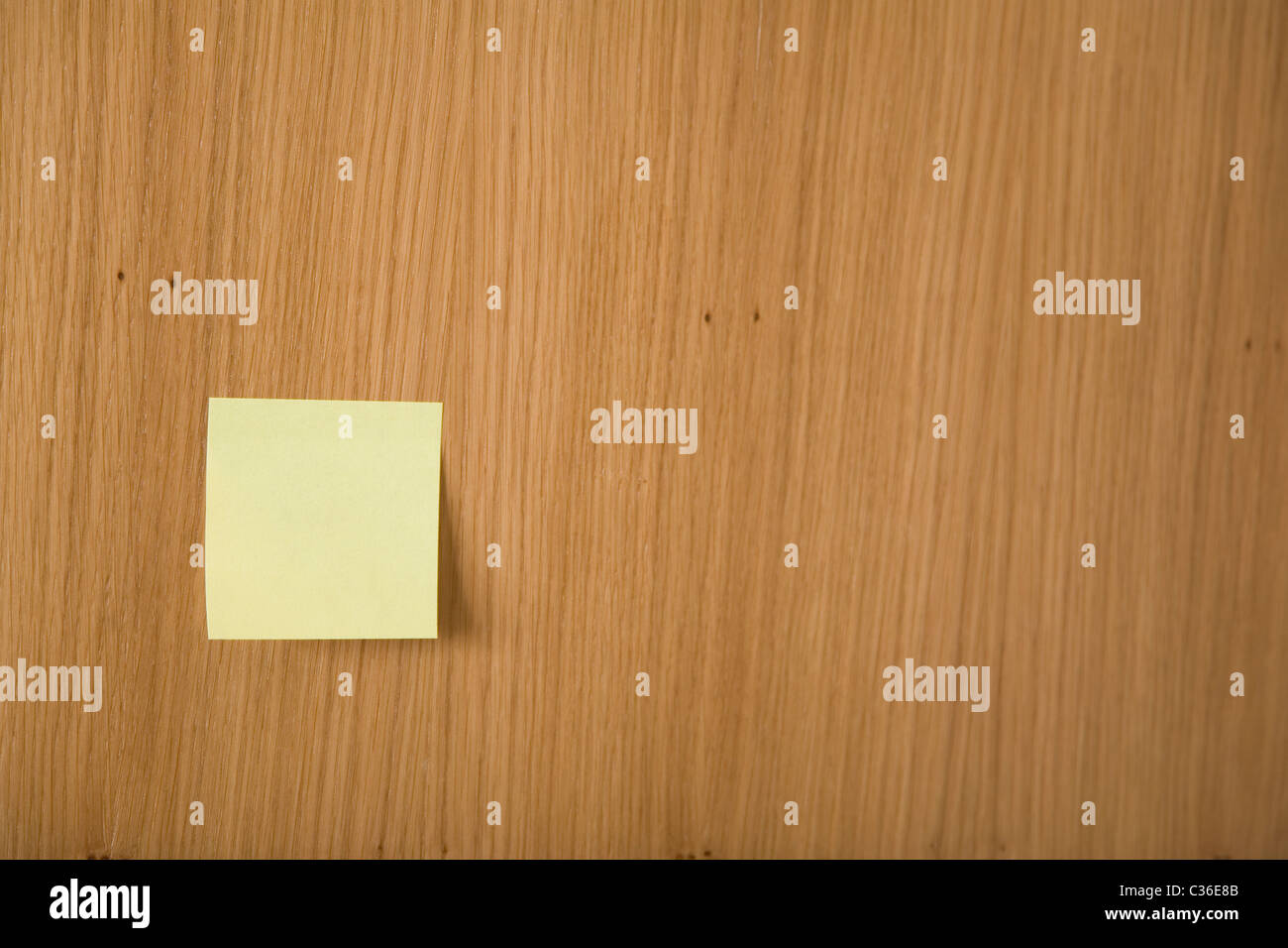 yellow post it on wooden board Stock Photo - Alamy