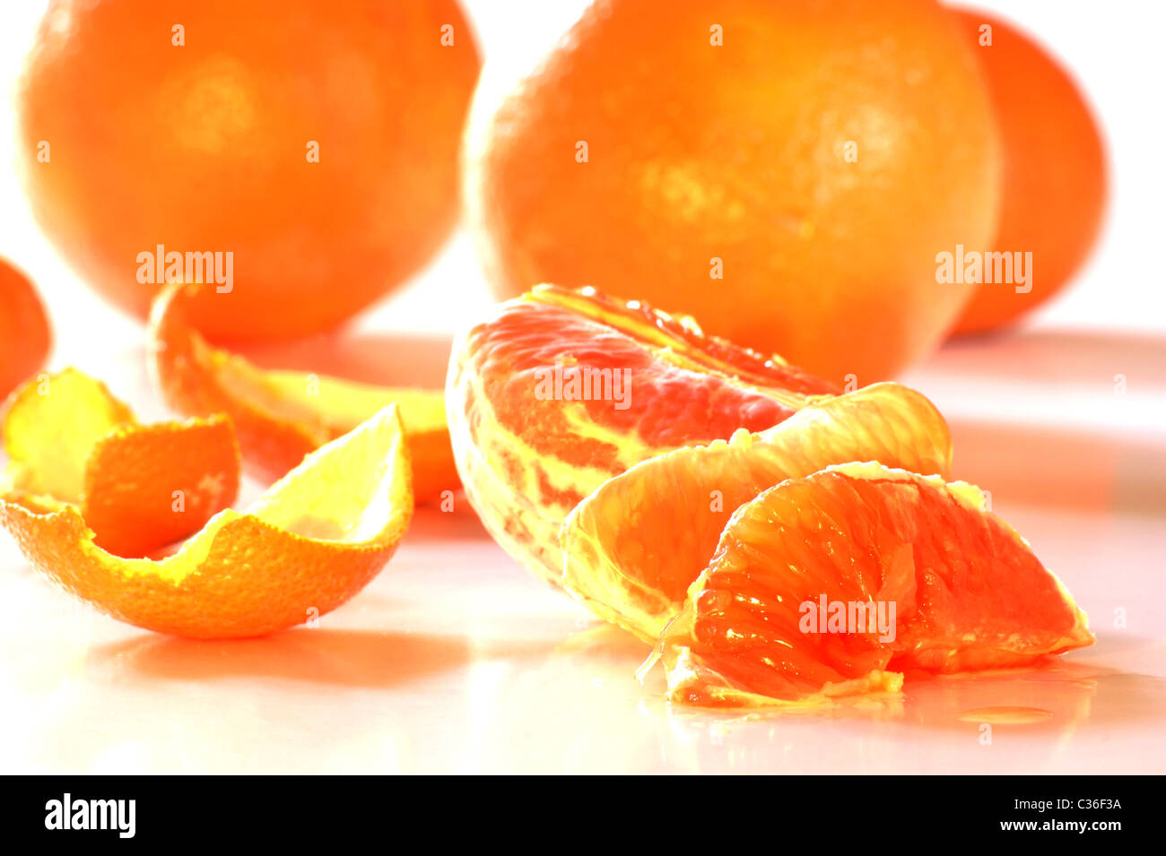peeled orange and whole oranges in the background Stock Photo - Alamy