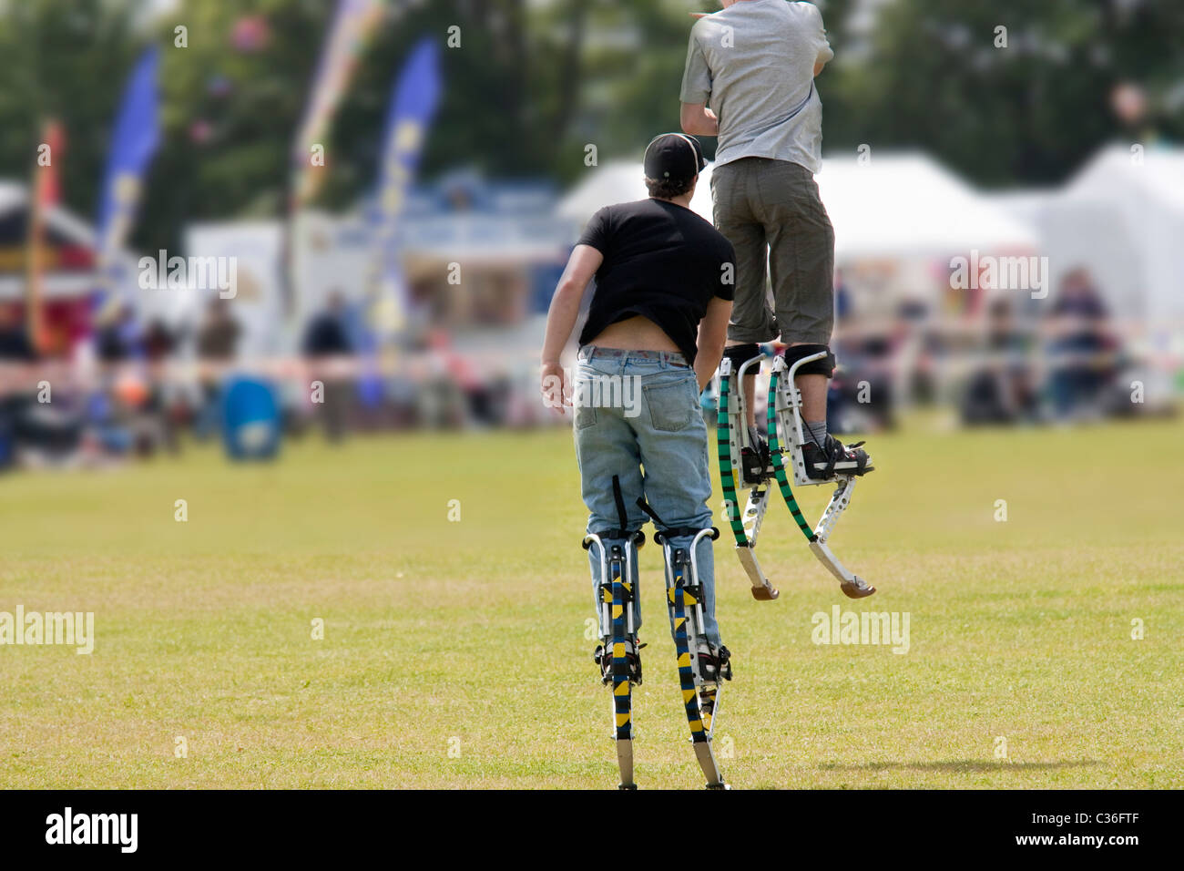 boys playing on the modern equivalent of stilts Stock Photo - Alamy