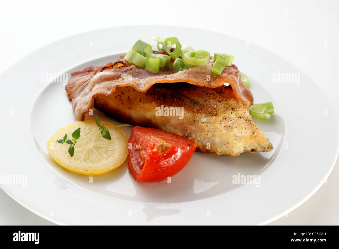 Fried chicken fillet with bacon and tomato Stock Photo - Alamy