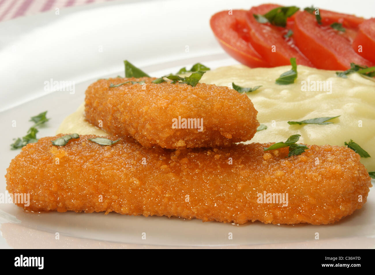 Fish fingers with mashed potatoes on a plate Stock Photo - Alamy