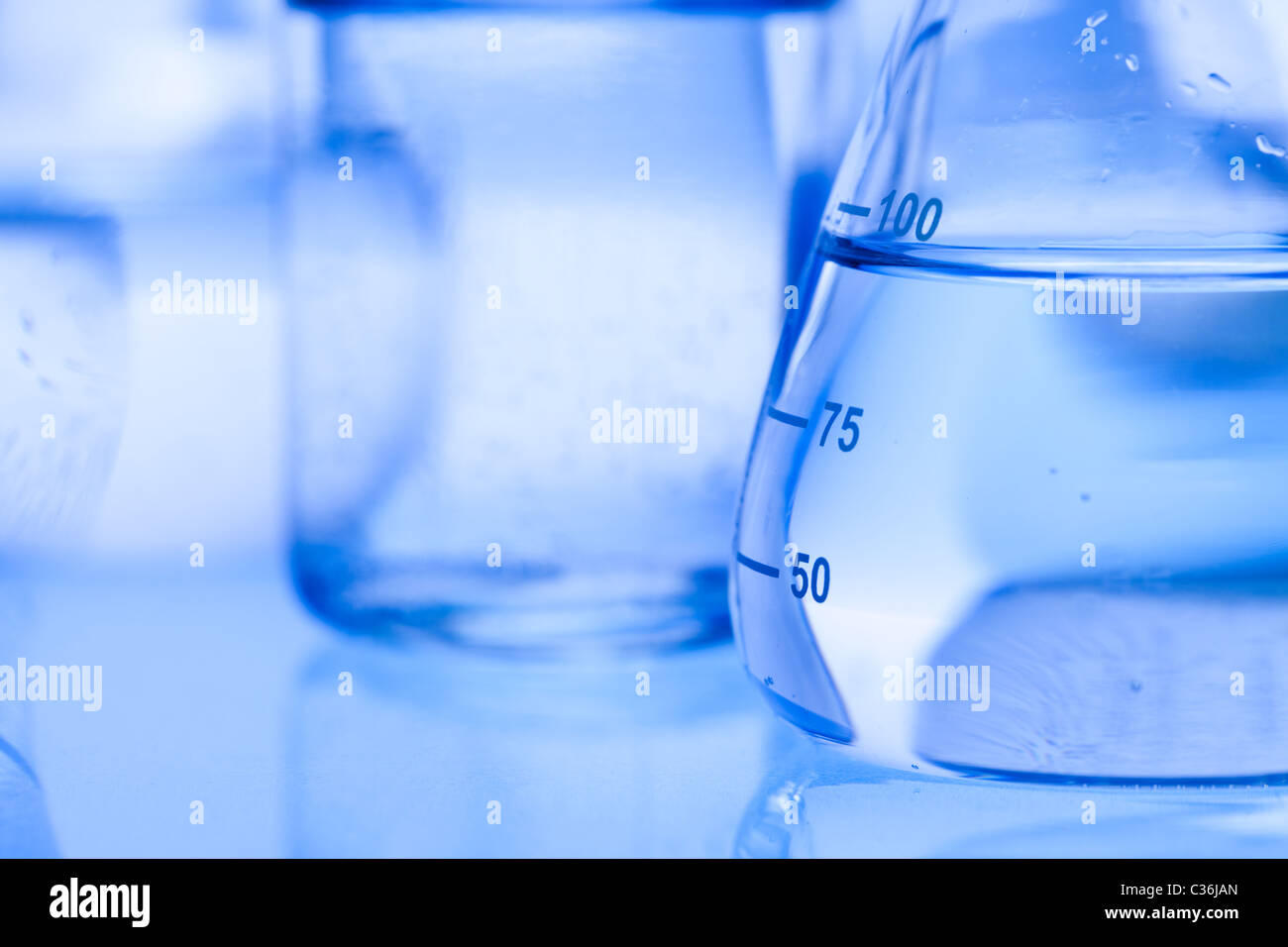 Laboratory glass in blue scenery Stock Photo - Alamy