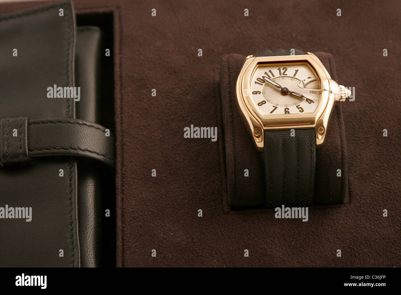 front view of black strap and gold watch Stock Photo - Alamy