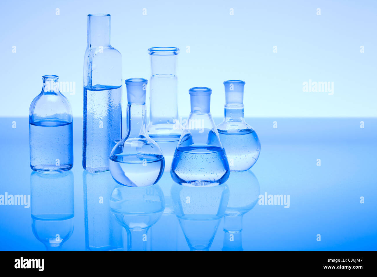 Laboratory glass in blue scenery Stock Photo - Alamy