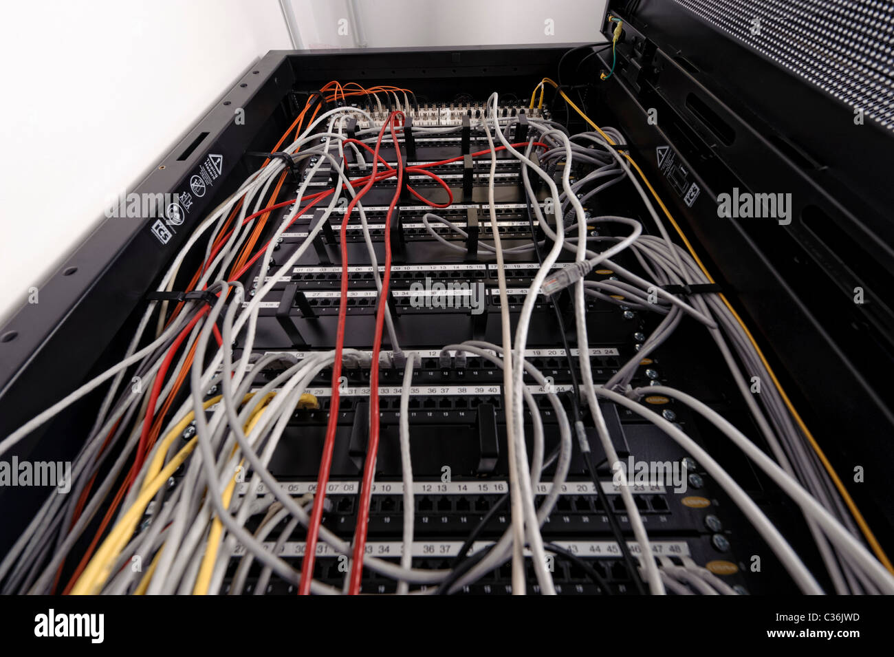 Low angle shot of network switch full of ethernet cables in server room ...