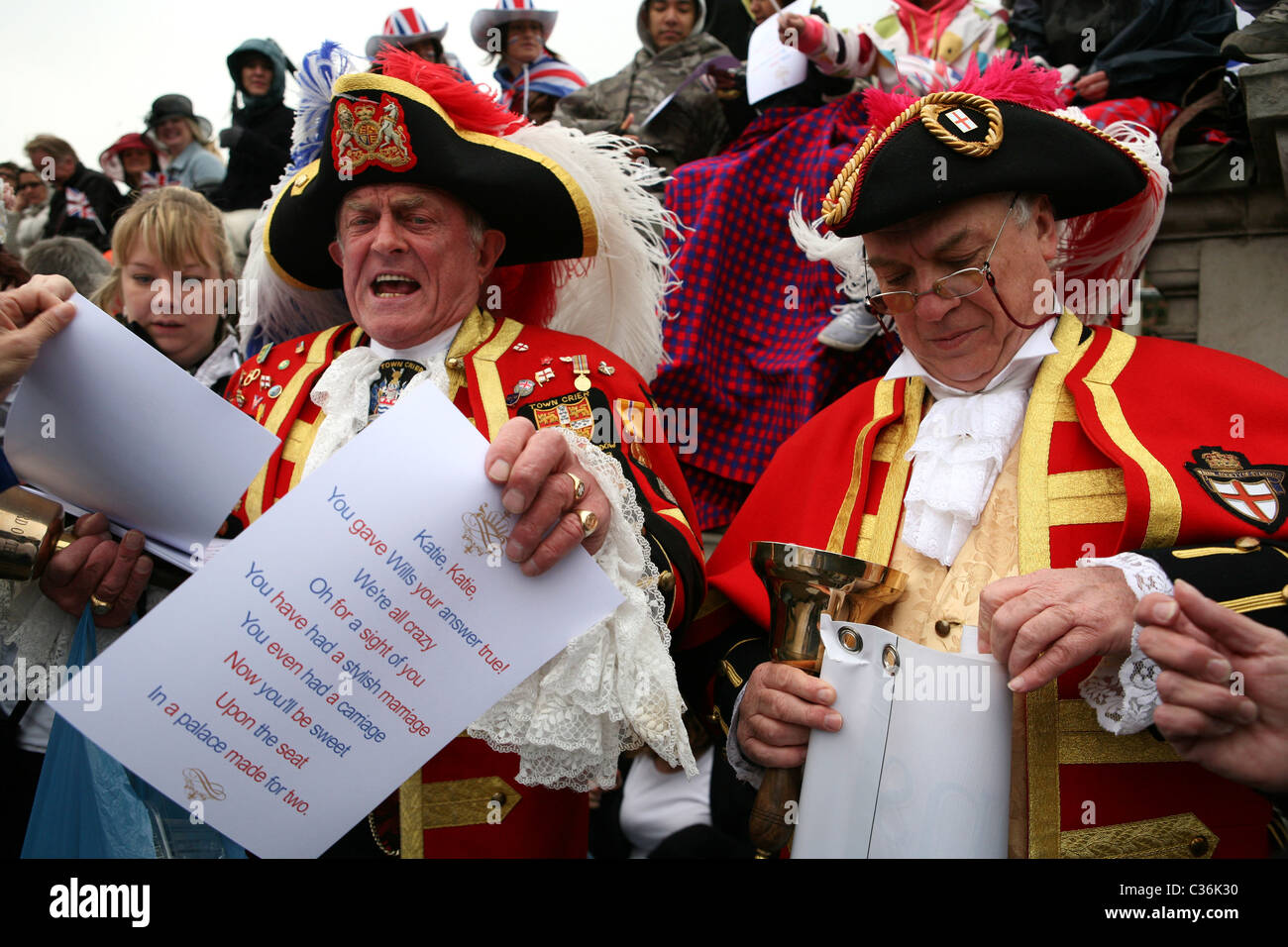 Dressed men are giving to people sheets with a text of a song dedicated ...