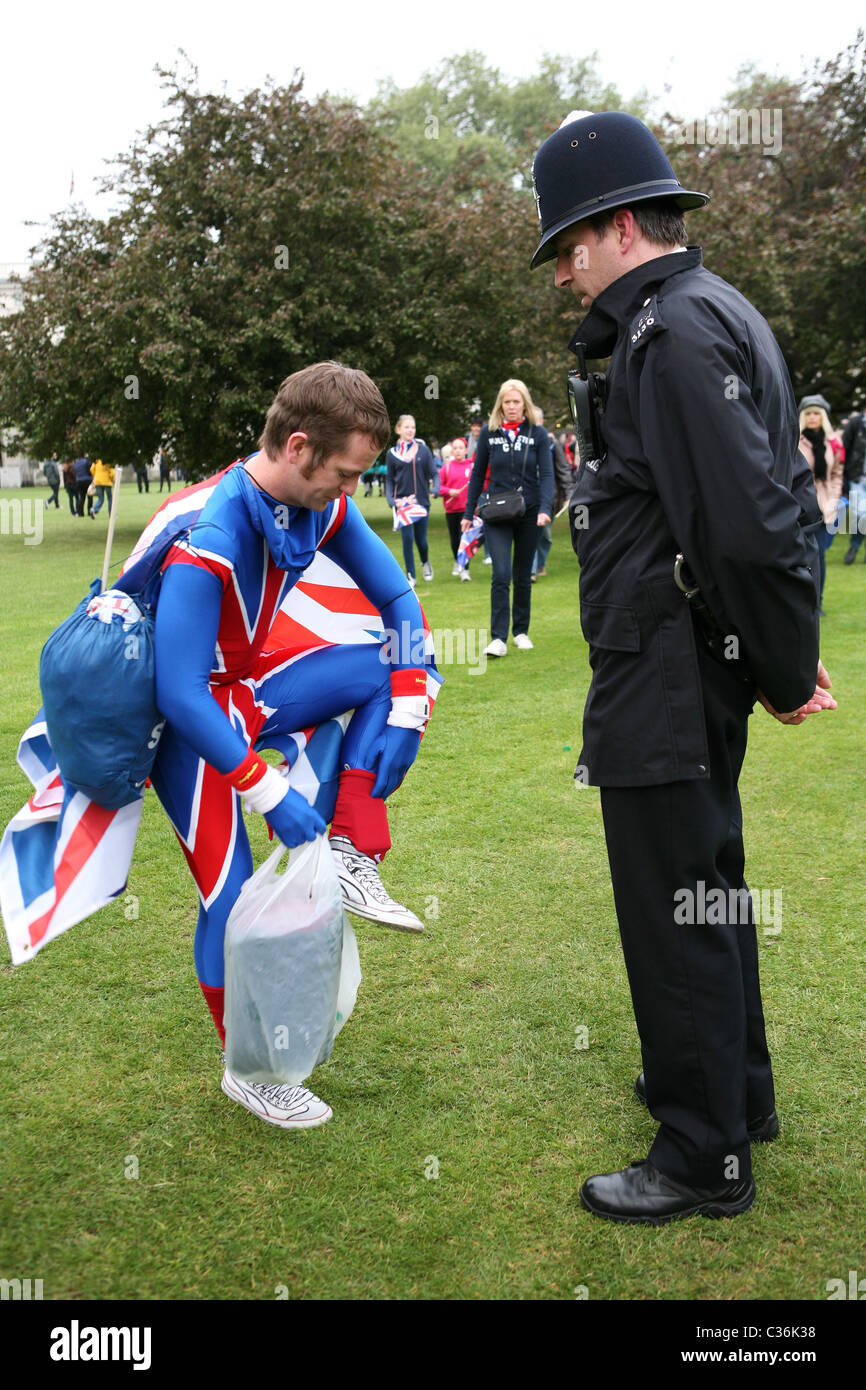A policeman is asking for the ID to a guy dressed with national colors ...