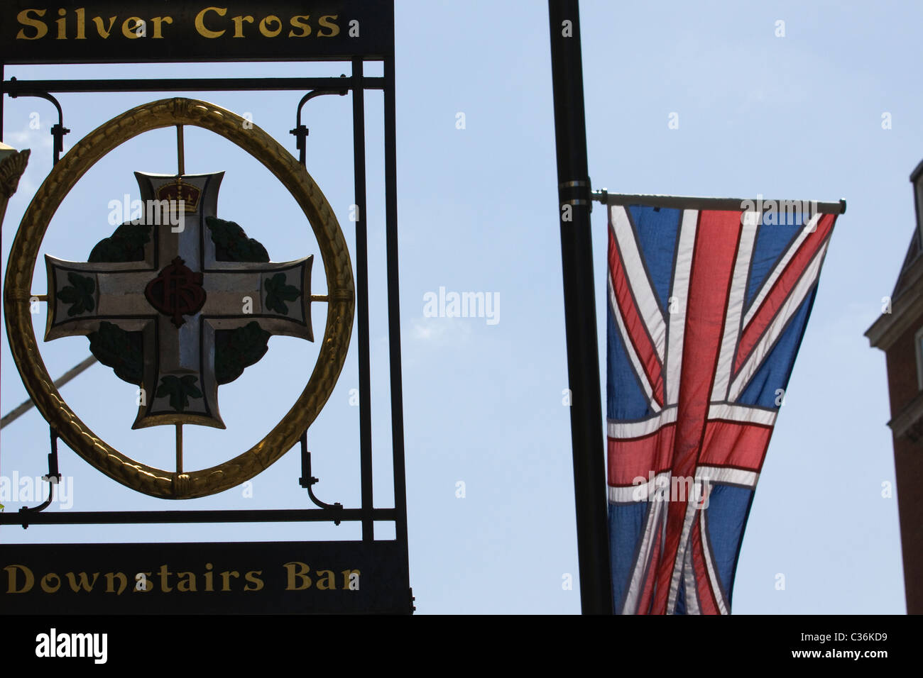 Union Jack Flag along side the silver cross Public House Sign hanging ...