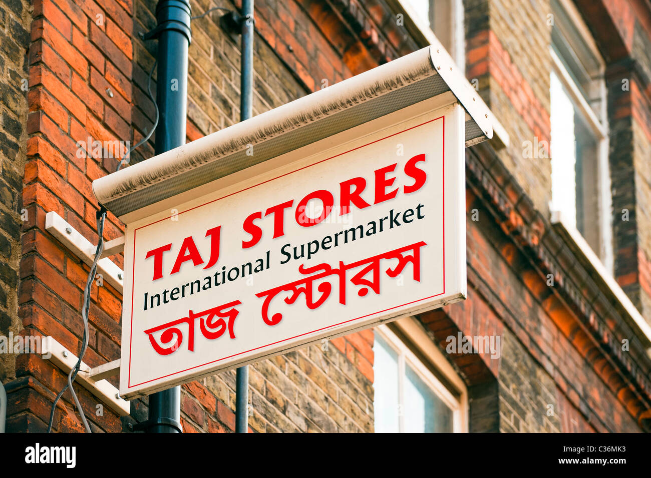LONDON, UK - APRIL 17, 2011: Bilingual Shop sign on Brick Lane in ...