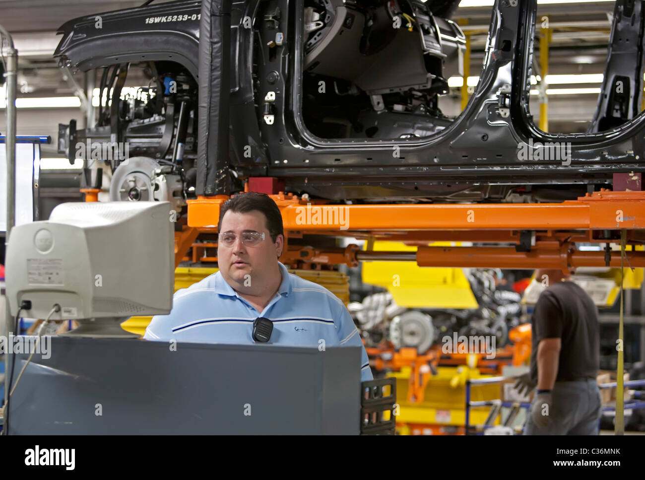 Detroit, Michigan - A worker checks a monitor along the assembly line ...
