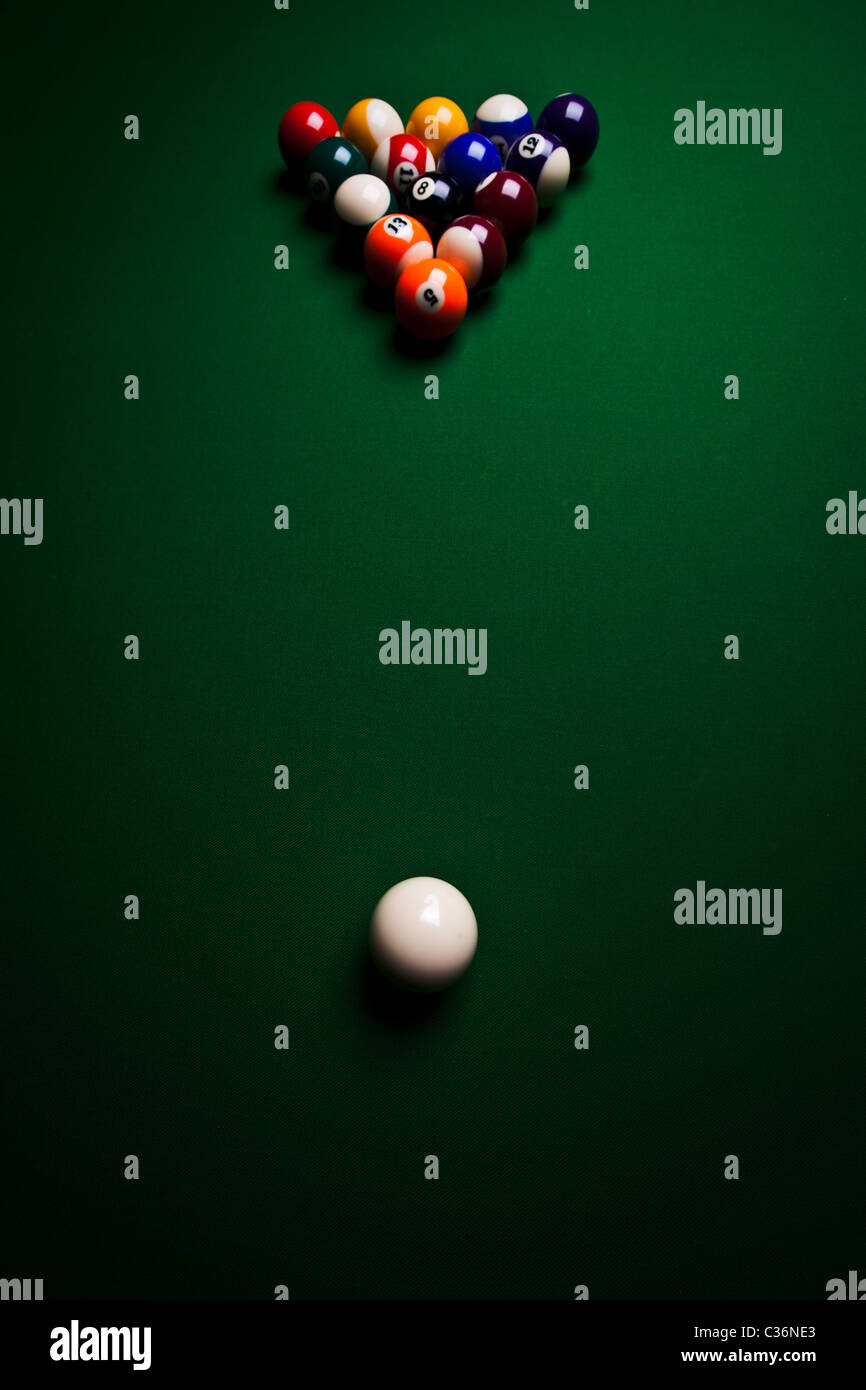 Billiard balls over green table Stock Photo - Alamy