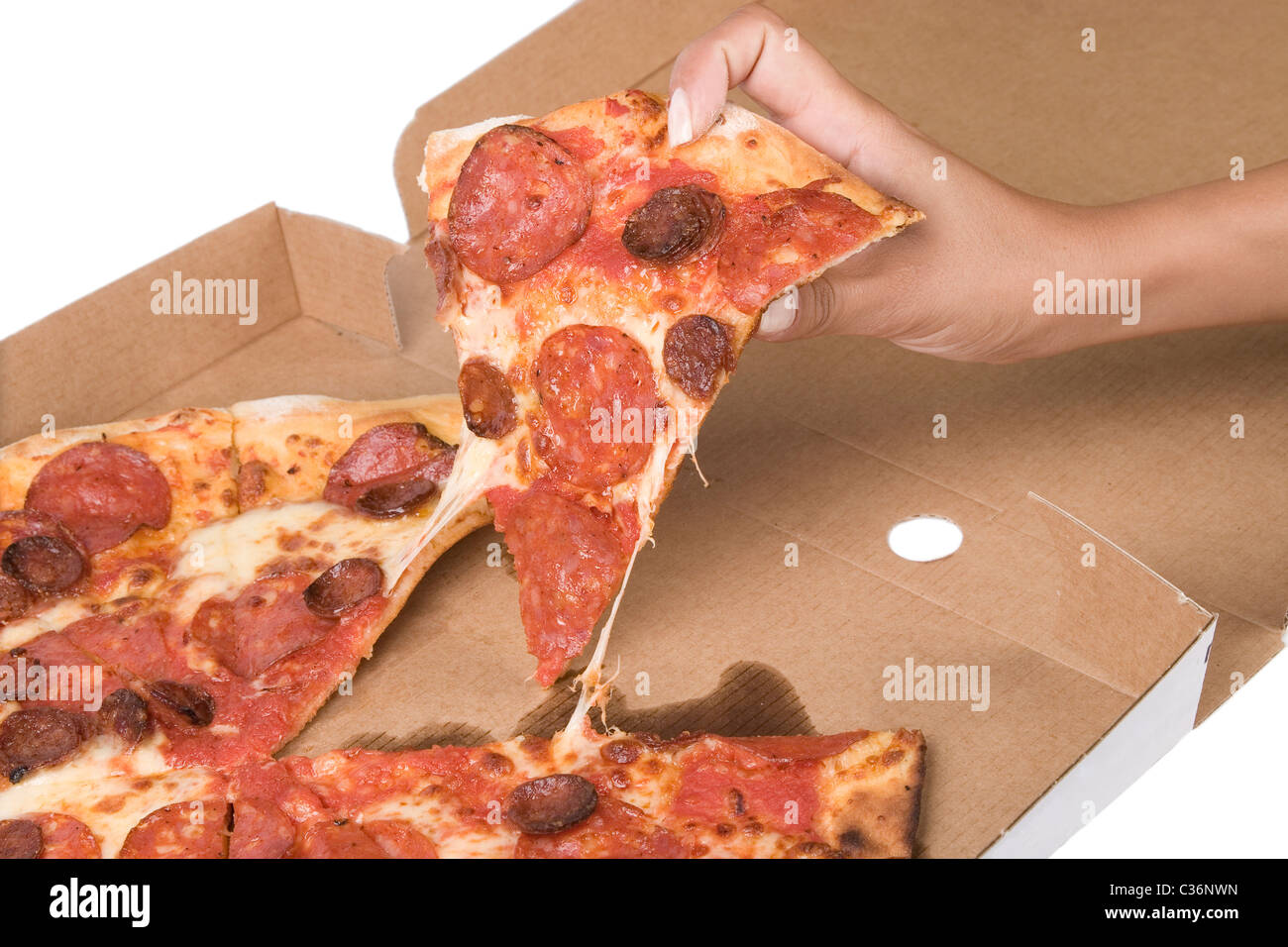 spicy pizza on cardboard box with hand Stock Photo - Alamy