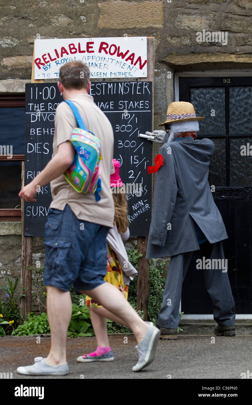 People walking past Bookmakers odds or display in High Street Betting ...
