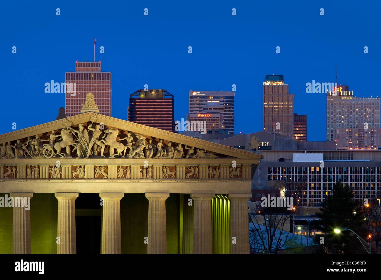 Parthenon replica at twilight with modern buildings of Nashville ...