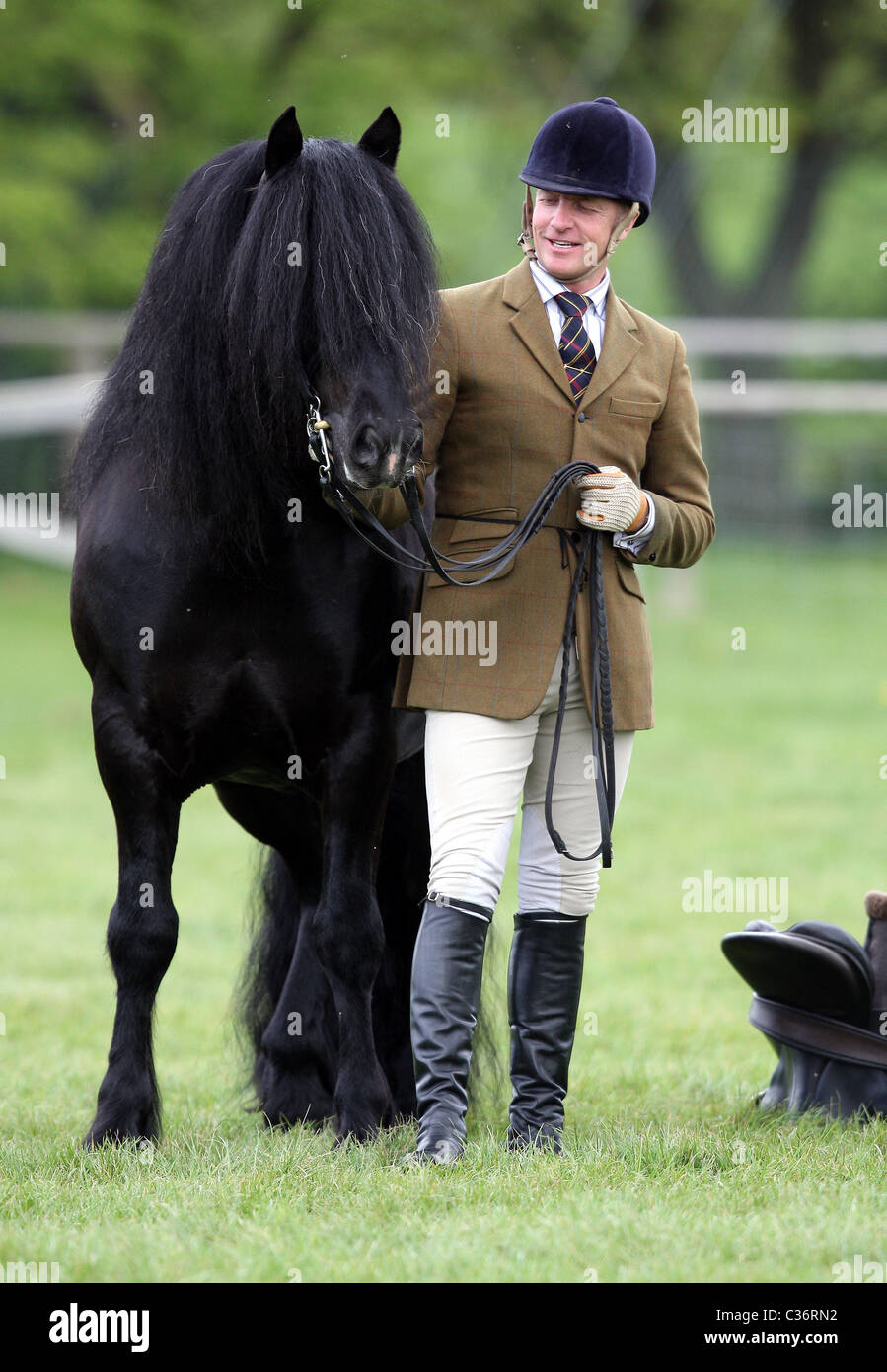 Male horse rider with his faithful companion and friend at a equestrian ...