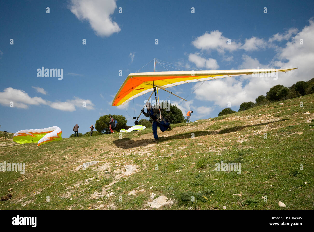 Hang glider pilot taking off from slope Stock Photo - Alamy