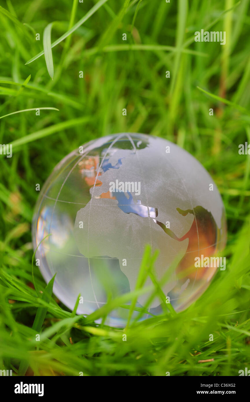 Glass globe in green grass global warming climate change earth ...