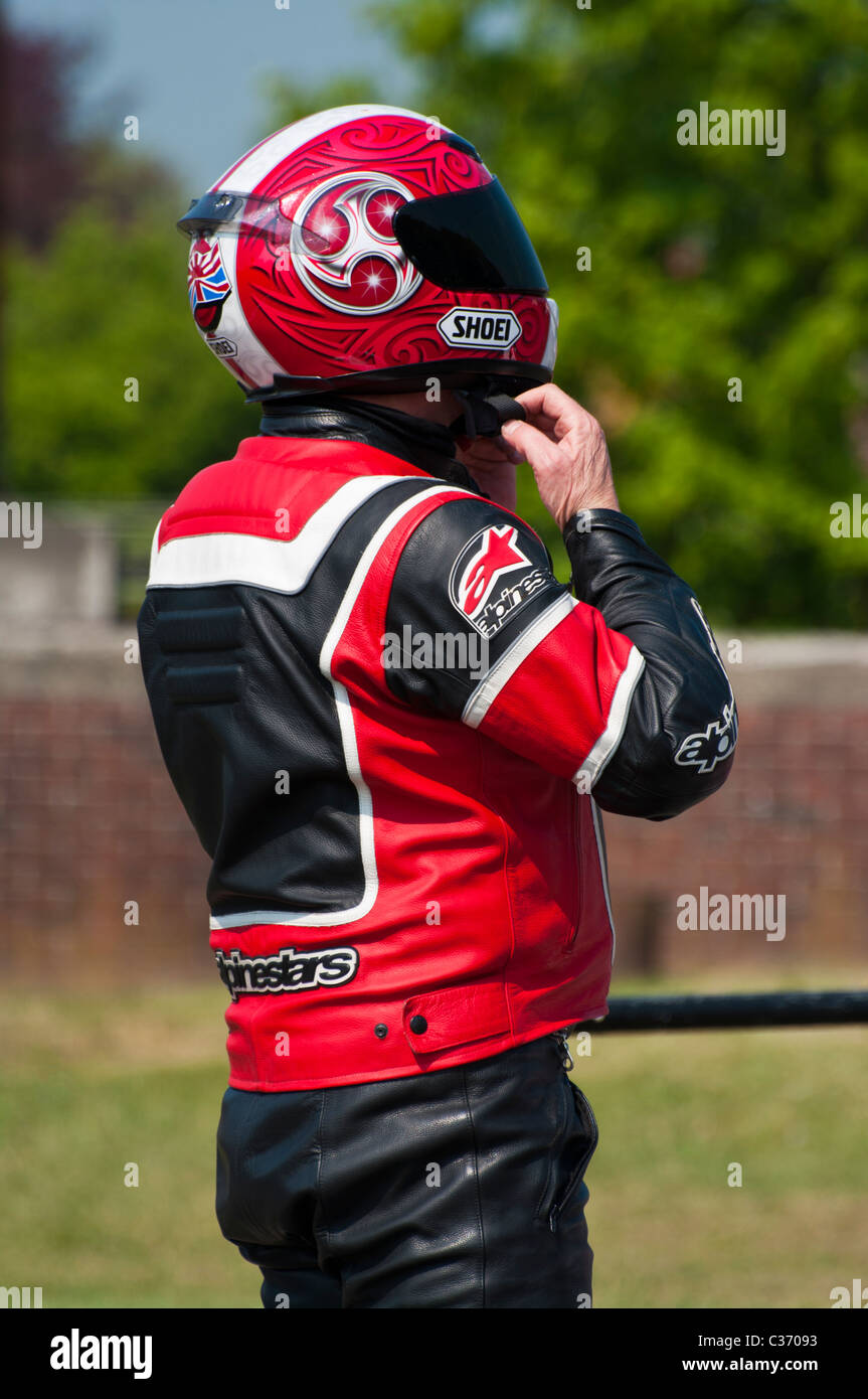 Motorcyclist Removing His Crash Helmet Stock Photo - Alamy